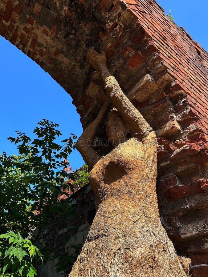 Wicker Statue of a Woman Under a Brick Wall Stock Photo - Image of ...