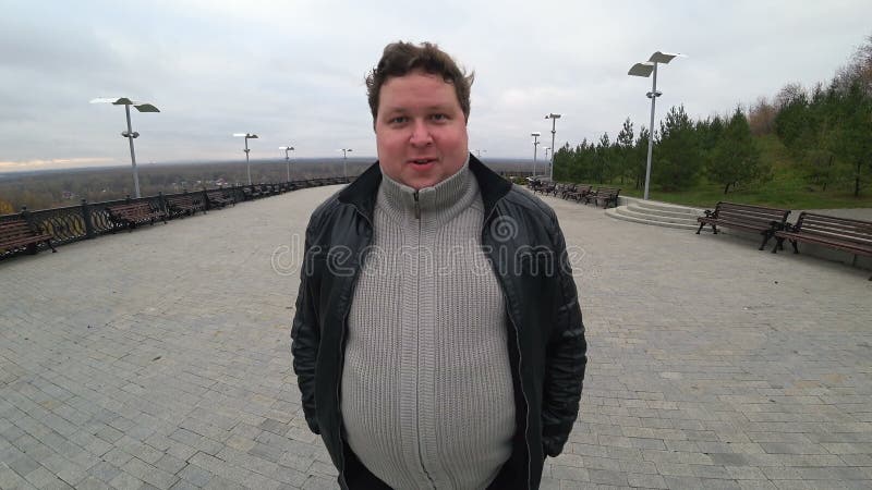 Wide Angle Lens: Young Fat Man Looking at Camera and Showing Silence ...