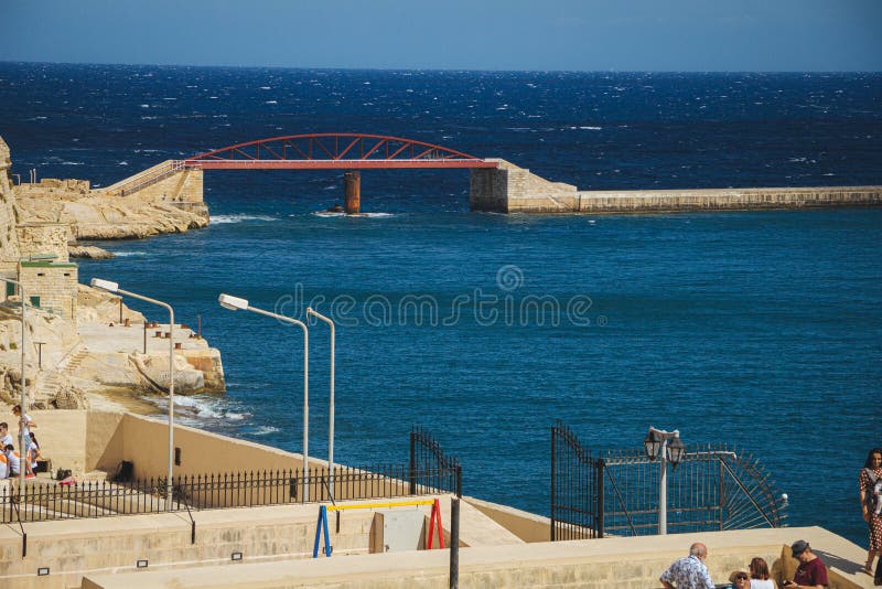Wide Angle Shot of a Bridge Made of Stone and Red Metal Going Over the ...