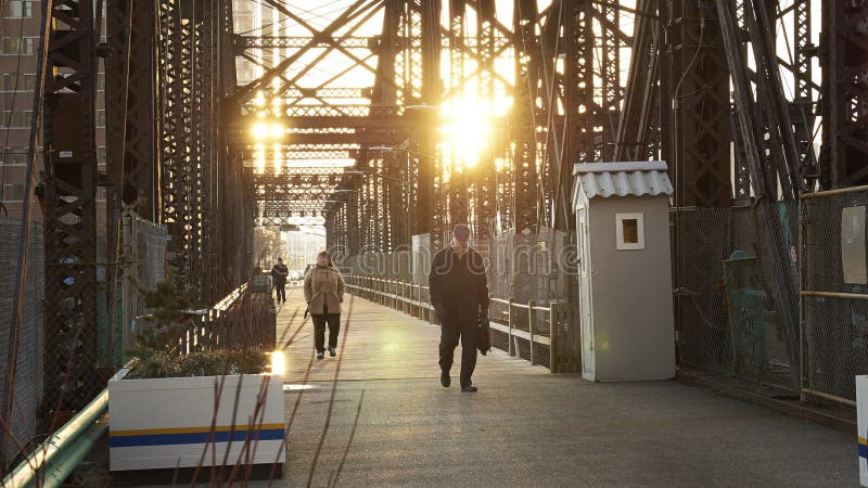 Wide Angle Shot of People Walking Next To a Large Metal Construction ...