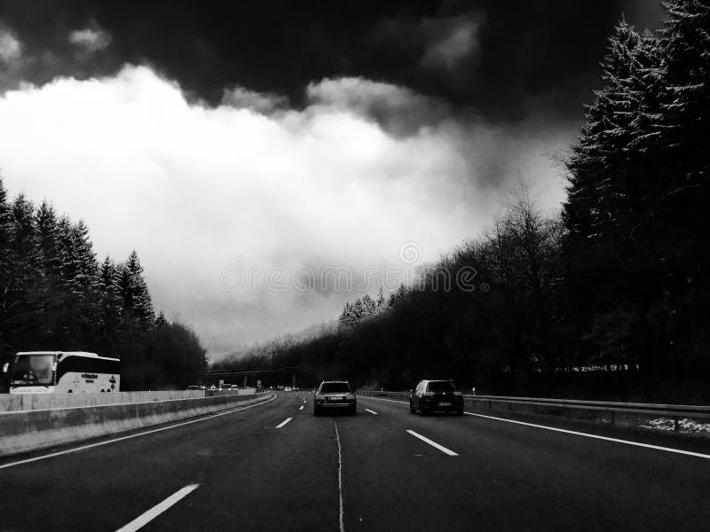 Wide Angle Shot of Several Cars on a Road Surrounded by Trees Stock ...
