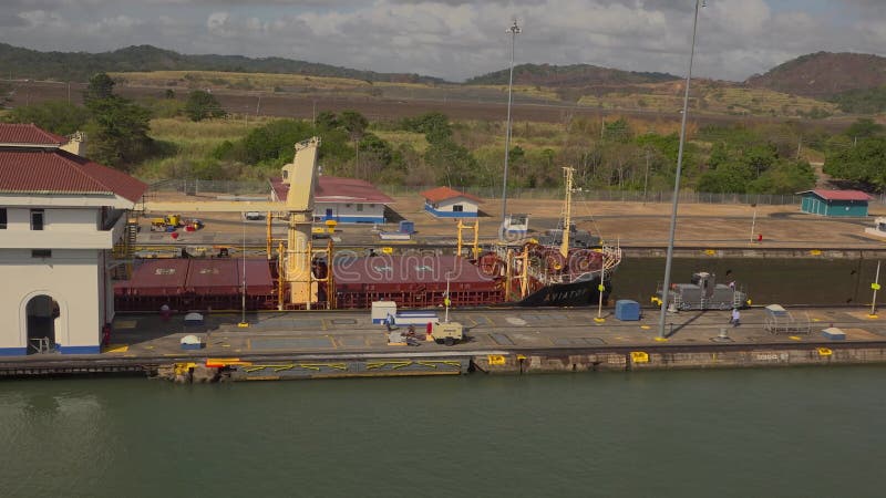 A Ship Being Pulled and Guided through a Lock on the Panama Canal Stock ...