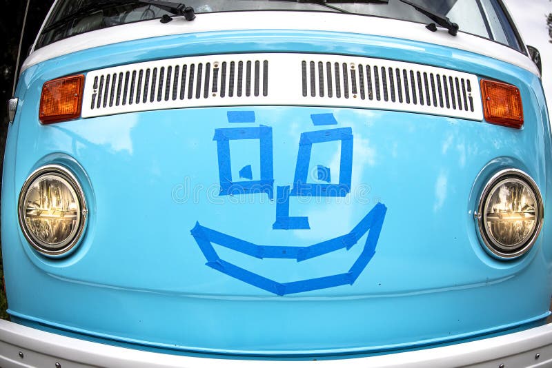 Wide Angle View of Vintage Powder Blue Bus with a Smiley Face on the ...