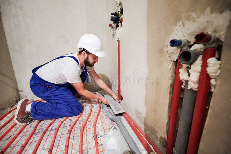 Bearded Plumber Installing Underfloor Heating System Stock Photo ...