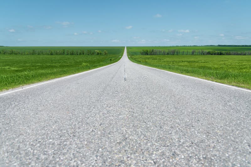 A Wide Asphalt Road between Green Fields Stock Photo - Image of prairie ...