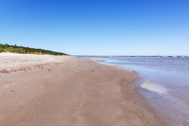 .a Wide Beach with Sand and a Seashore Where the Water Slowly Meets the ...