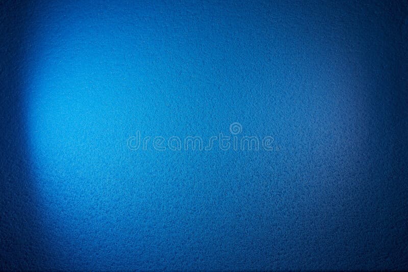 A Wide Beam of Light Blue from the Side Shines on a Textured Blue ...