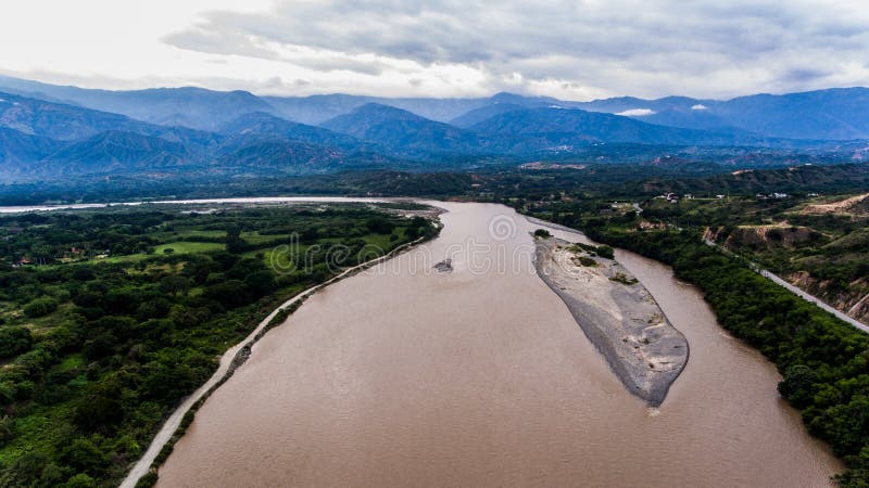 Wide Brown River with Chain of Mountains Stock Image - Image of ...