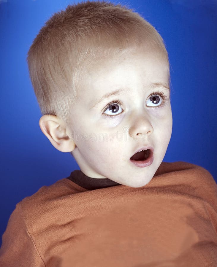 A Wide Eyed Toddler Looks Surprised Stock Photo - Image of cheeky ...