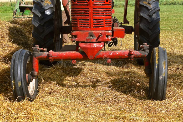 Wide Front Wheeled Red Tractor Pulling a Baler Stock Photo - Image of ...