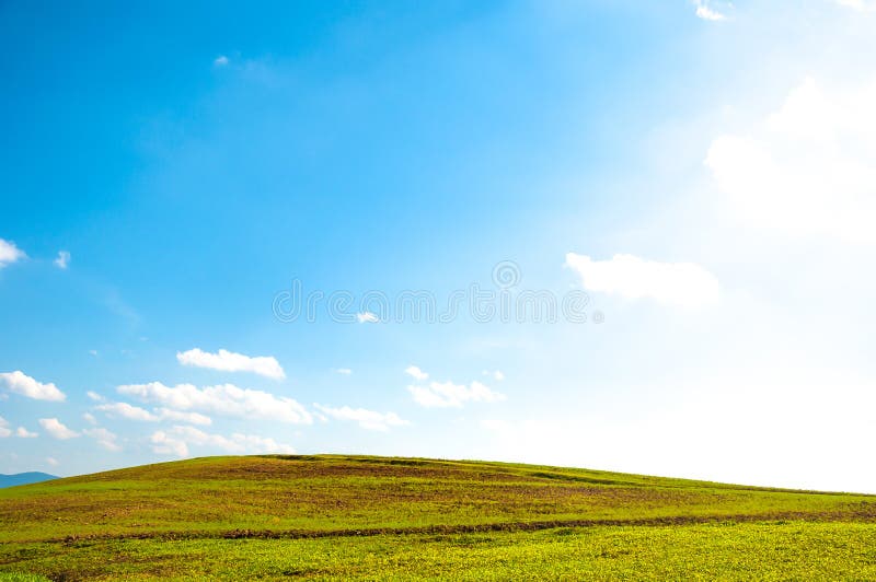 Wide Green Field on Rolling Hills and Blue Sky with Clouds Stock Photo ...
