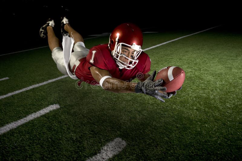 Wide Receiver Making a Diving Catch Stock Photo - Image of black ...