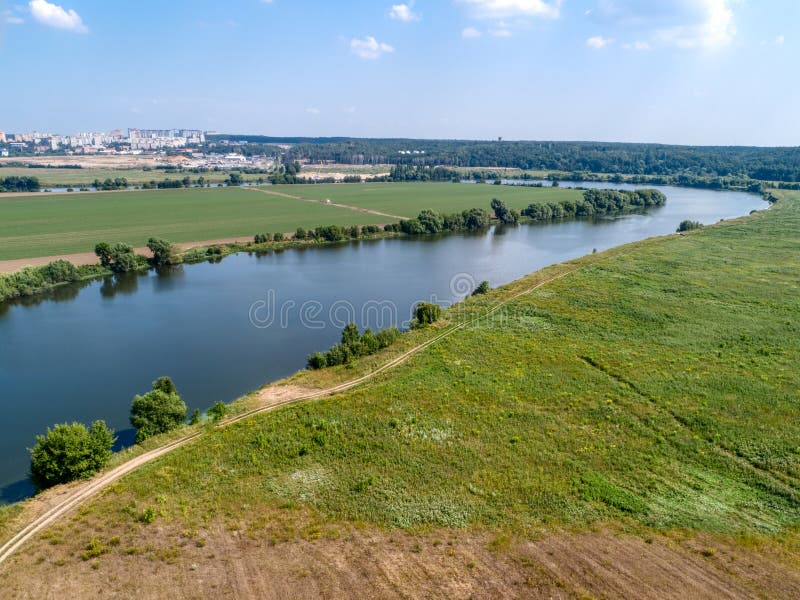 Wide River Flowing between Fields Stock Photo - Image of large, spring ...