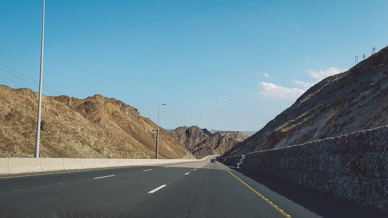 Wide Road Leads Towards the Mountains, Palm Trees on the Roadside Stock ...