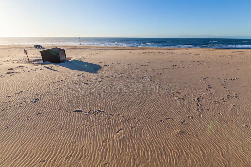 Wide Sandy Beach Stretches Towards Ocean Under Clear Blue Sky Stock ...