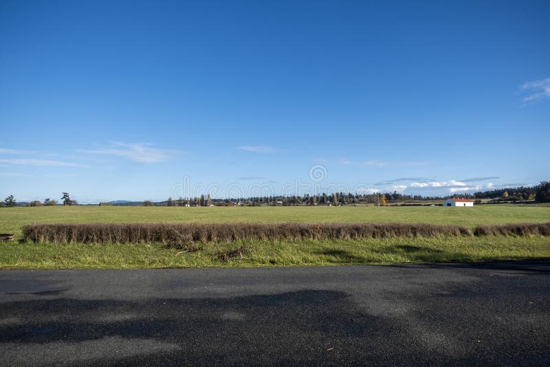 Wide, Scenic View of a White Barn on a Large Plot of Farm Land in the ...