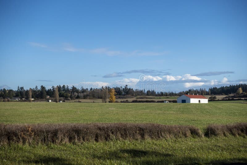 Wide, Scenic View of a White Barn on a Large Plot of Farm Land in the ...