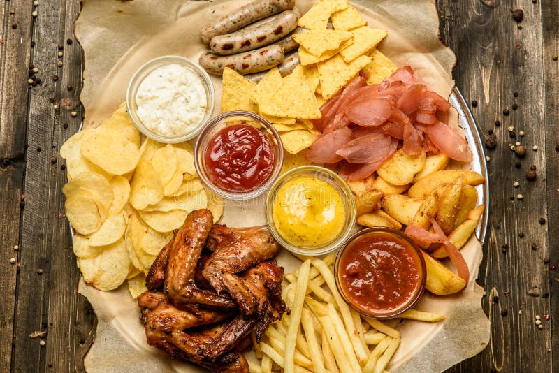 Wide Selection of Snacks for Beer with Different Sauces on Parchment ...