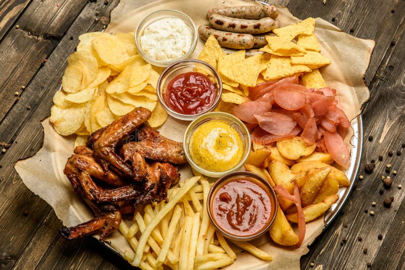 Wide Selection of Snacks for Beer with Different Sauces on Parchment ...