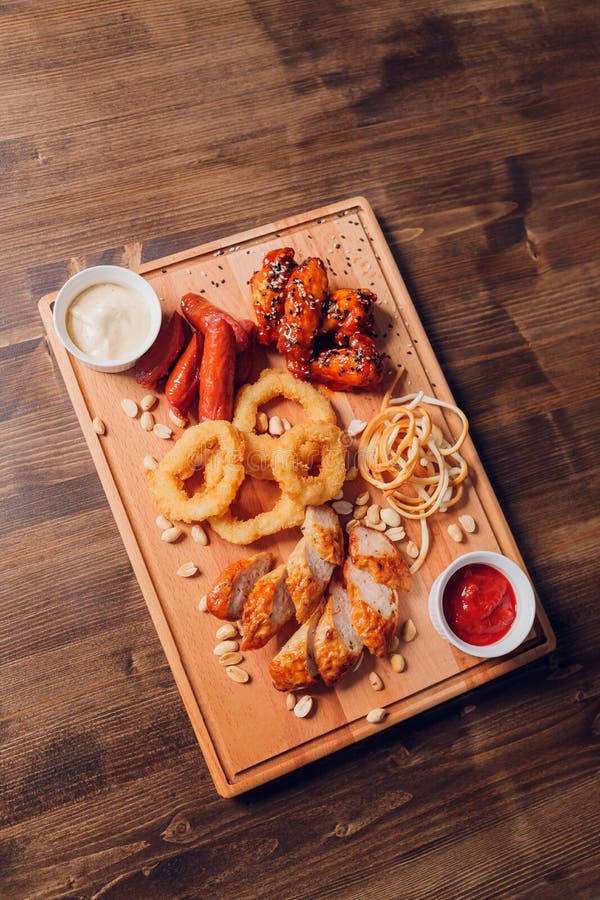 Wide Selection of Snacks for Beer with Different Sauces on Parchment ...