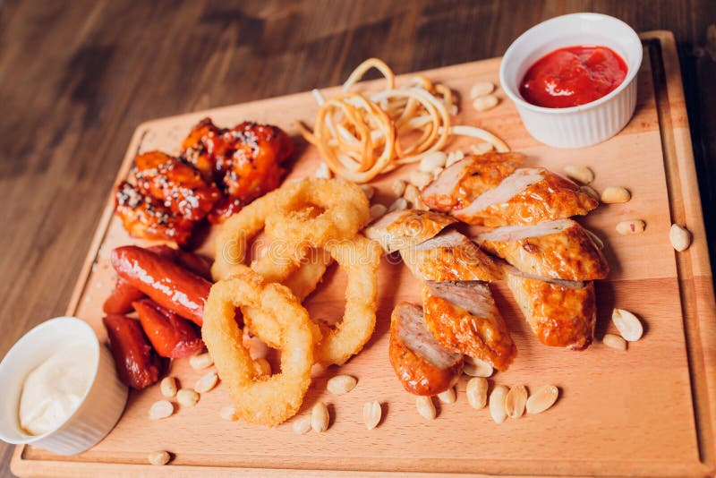 Wide Selection of Snacks for Beer with Different Sauces on Parchment ...