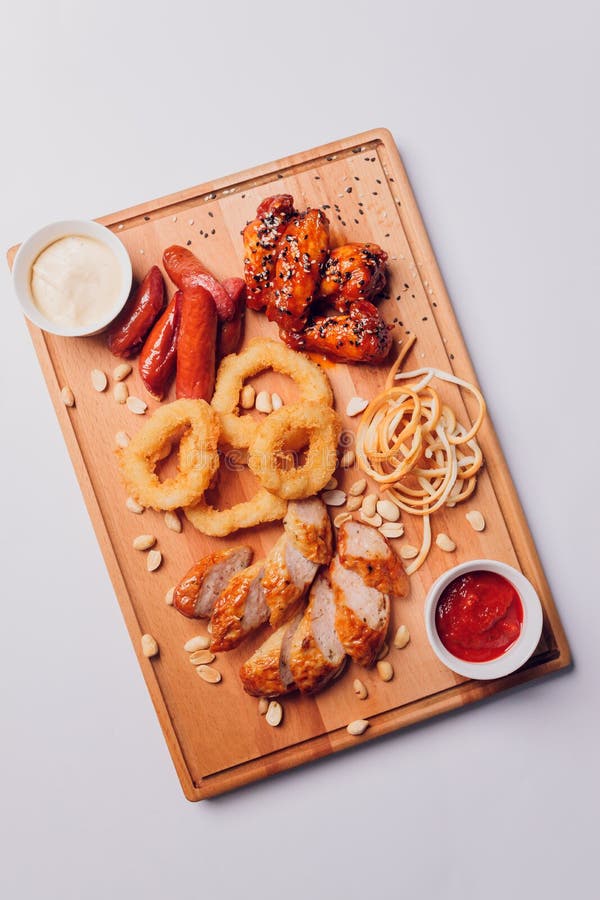 Wide Selection of Snacks for Beer with Different Sauces on Parchment ...