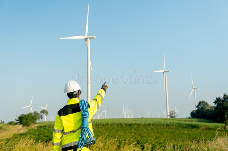 Wide Shot of Back of Wind Turbine or Windmill Engineer Worker Point To ...
