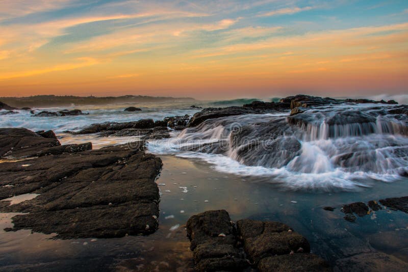 Wide Shot of the Beach with Rock Formations during Sunset with a ...