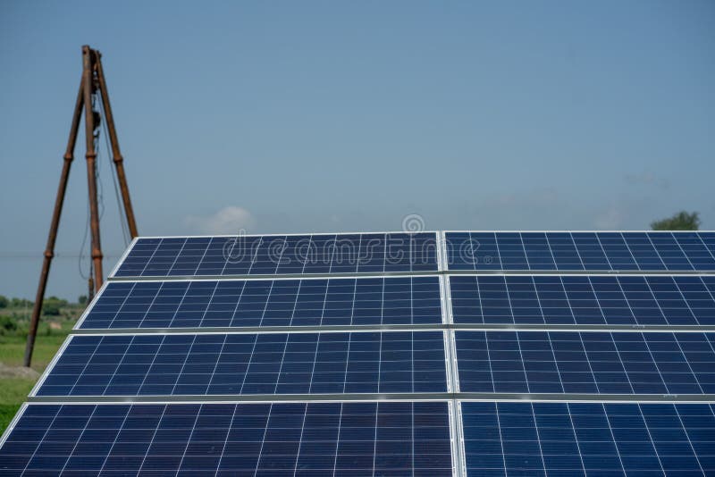 Wide Shot of a Big and Tilted Solar Panel in a Field of Grass on a ...