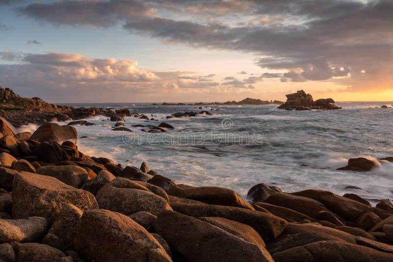 Wide Shot of the Ocean with Rock Formations by the Shore during Sunset ...