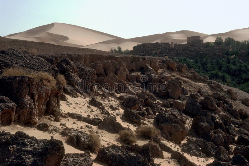 Wide Shot of a Rocky Hill Surrounded by Sandy Mountains and Trees Stock ...