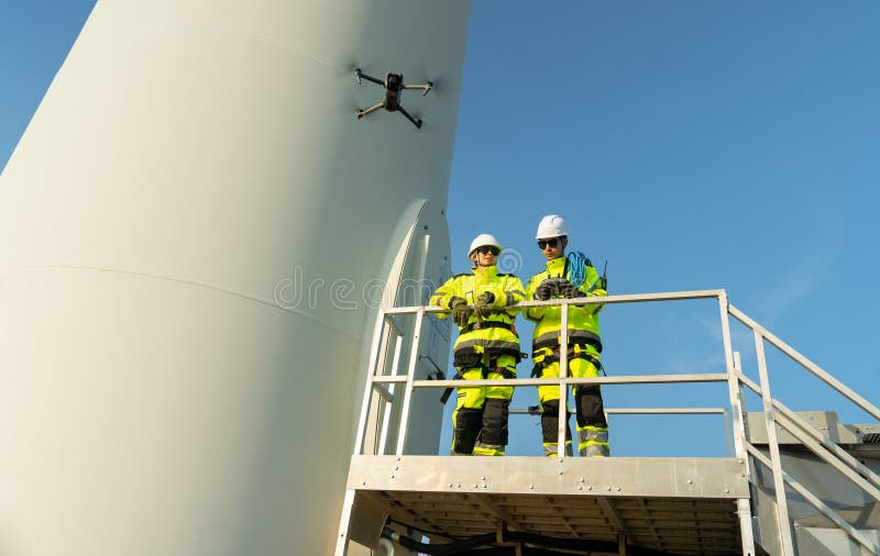 Wide Shot Two Wind Turbine or Windmill Workers or Engineer Stand on ...