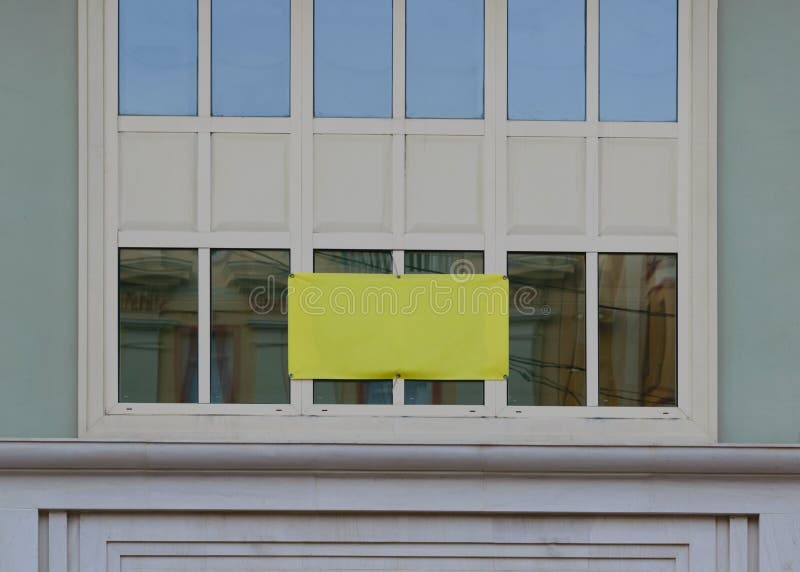 Wide Shot of the Yellow Plastic Sheet Covering Two Window Panels of a ...