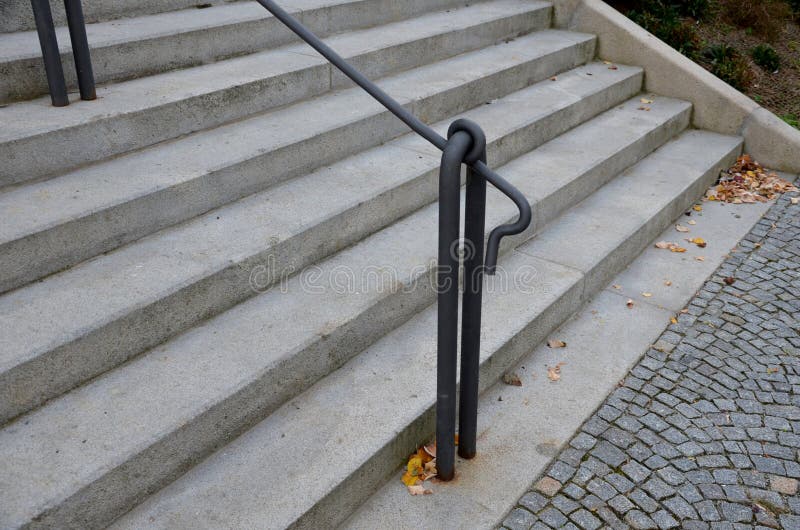 Wide Stone Staircase with Railings in the Middle of the Ramp. Forged ...