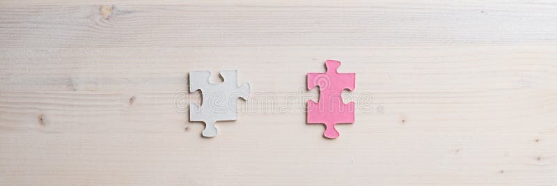 Wide View Image of Two Matching Puzzle Pieces Placed Over Wooden ...