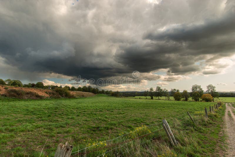 A Wide View Over Meadows, Under Dramatic Storm Clouds. Stock Image ...