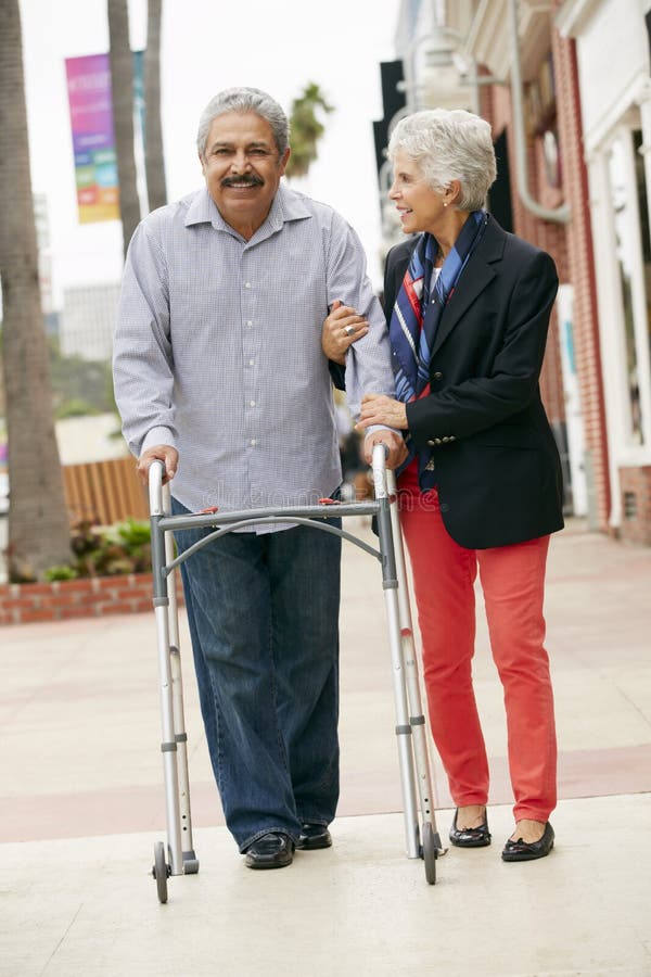 Wife Helping Senior Husband To Use Walking Frame Stock Photo - Image of ...