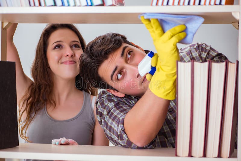 The Wife and Husband Cleaning Dust from Bookshelf Stock Image - Image ...