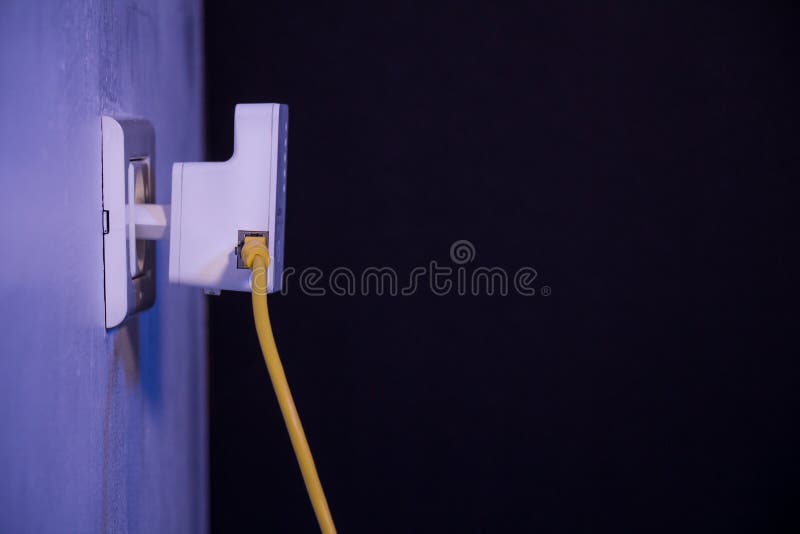 WiFi Extender in Electrical Socket on the Wall with Ethernet Cab Stock ...