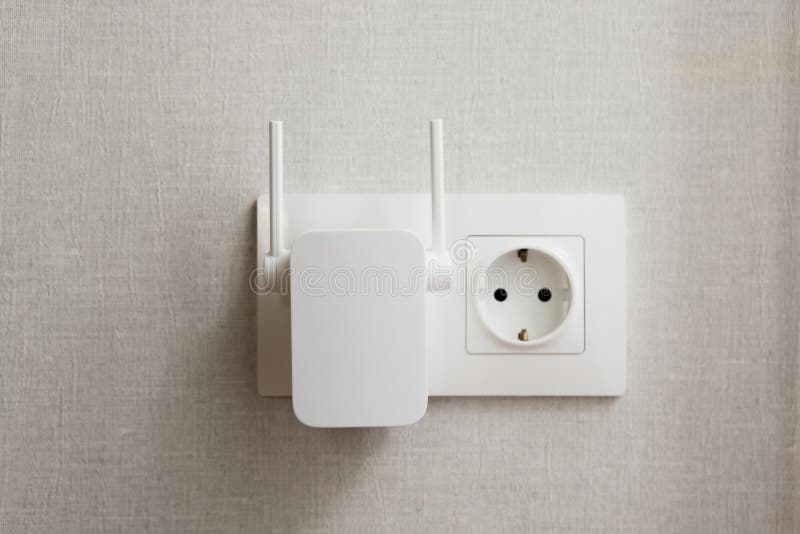 WiFi Range Extender Plugged into Wall Outlet on Textured Background ...