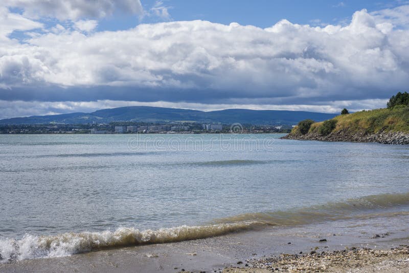 Wild Beach in Dublin, Ireland Stock Image - Image of clouds, green ...