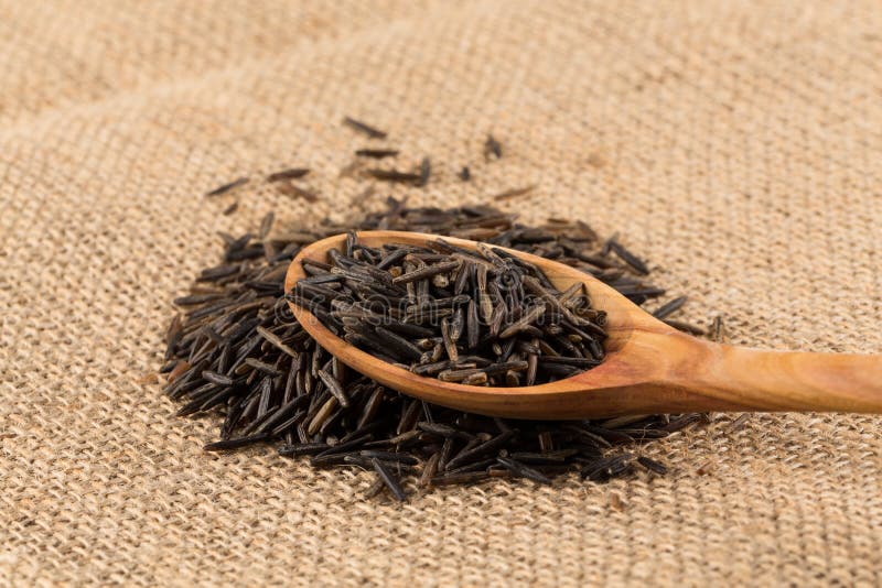 Wild brown rice in spoon stock photo. Image of closeup - 65520340