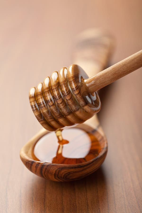 Wild Honey Pouring into Wooden Spoon from Dipper Stock Image - Image of ...