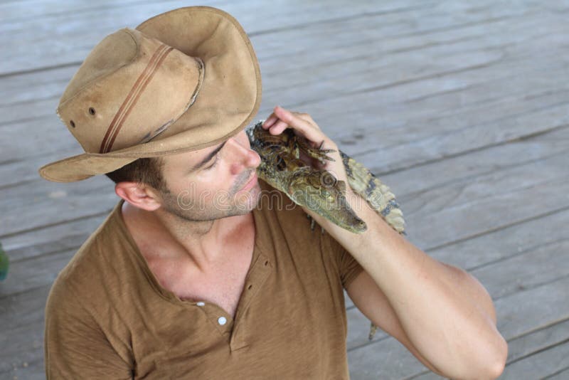 Wild man holding a caiman stock photo. Image of crocodilian - 167159124
