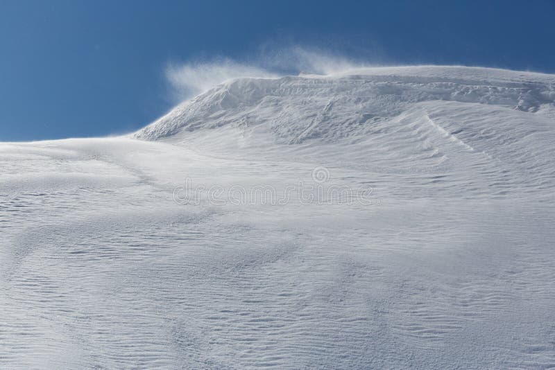 Wind Blowing Over Snow Cornice in Winter Landscape with Blue Sky Stock ...