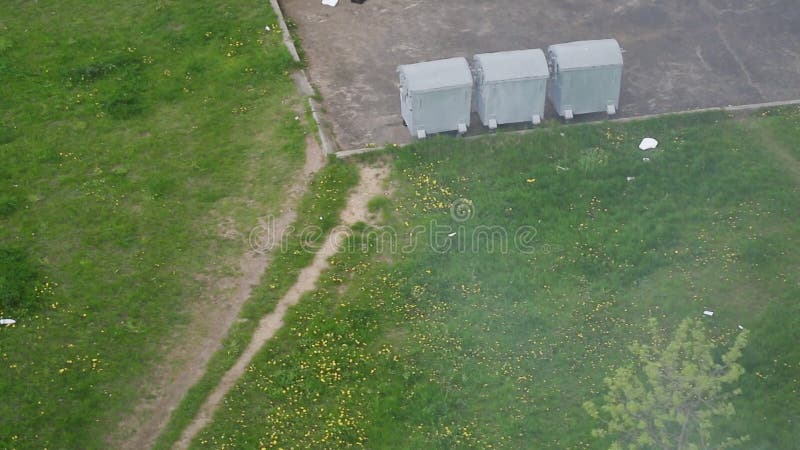 The Wind Blows Garbage from Garbage Cans Over the Grass in the ...