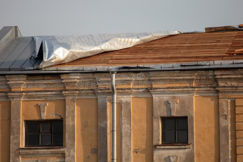 Wind-damaged Roof of a Building Stock Photo - Image of tile, wind ...