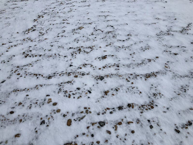 Wind driven snowy beach stock photo. Image of shingle - 139006560