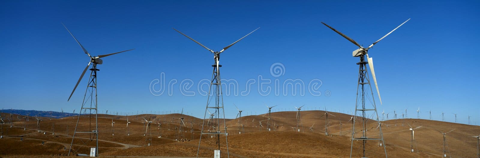 Wind Energy.Windmills and People Near on the Road on a Blue Sky ...