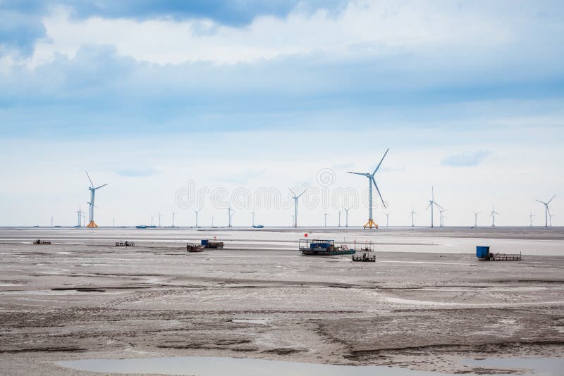 Wind farm in mud flat stock photo. Image of resource - 42520304